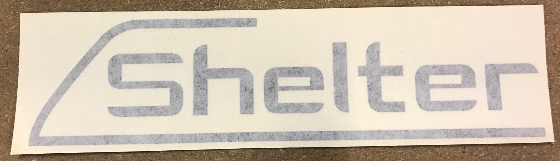 STICKER SHELTER logo 20 cm x 4.4 cm zwart